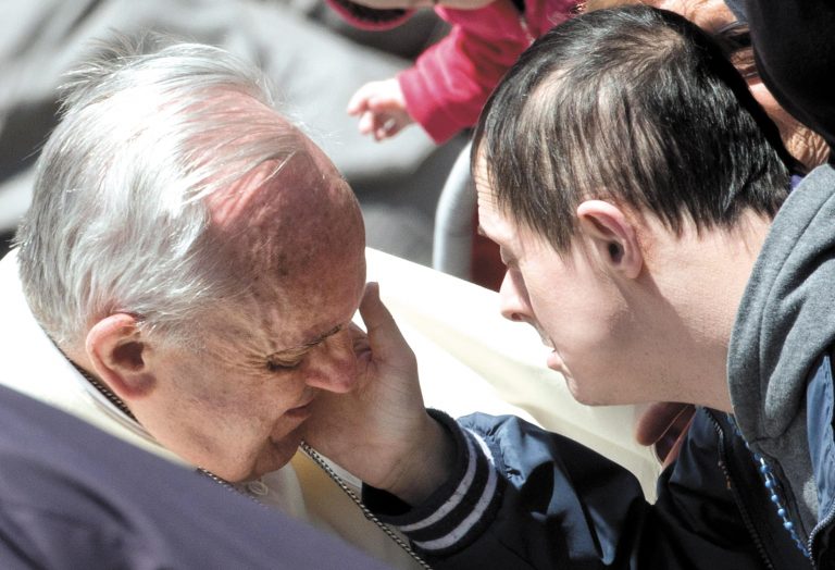 Young man touches cheek of Pope Francis during pontiff's weekly ...
