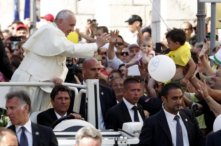 Pope Francis waves as he arrives to celebrate Mass in Italian town ...
